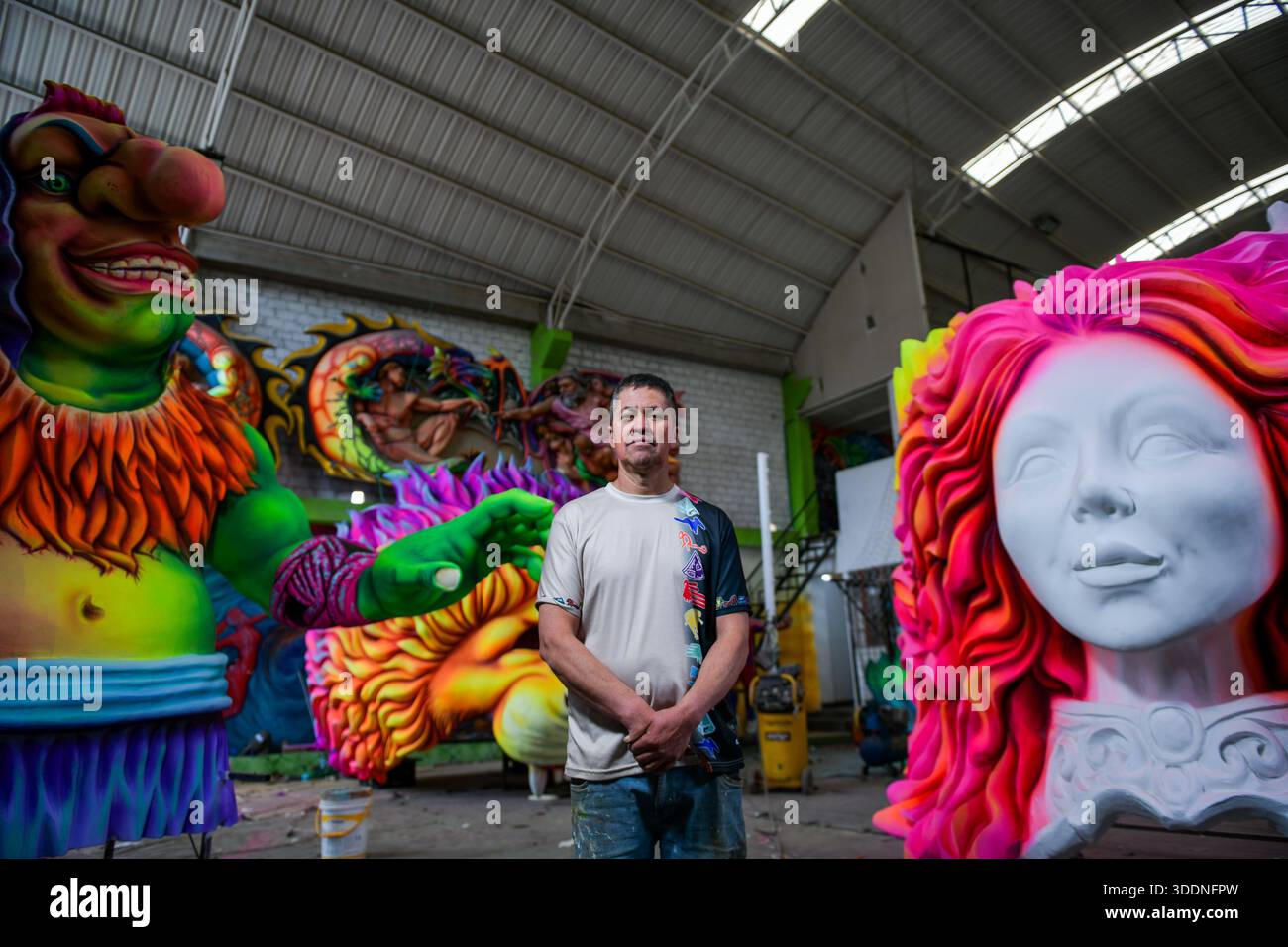 Master artisan Miguel Mejia works on the float “Encanto”, set to parade ...