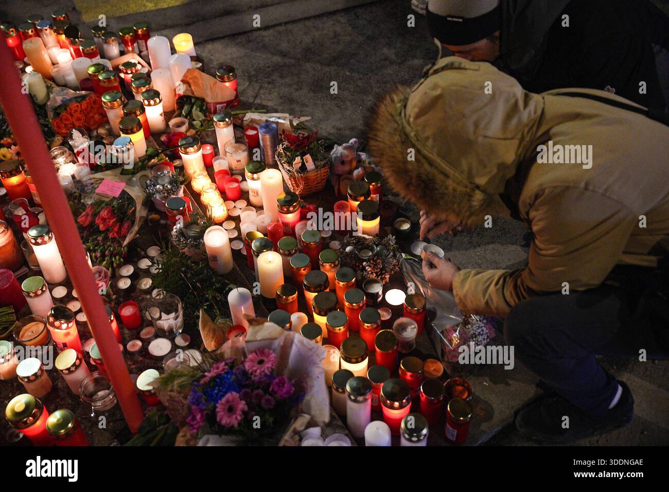 People lay flowers and candles near the Le Constellation bar, where a ...