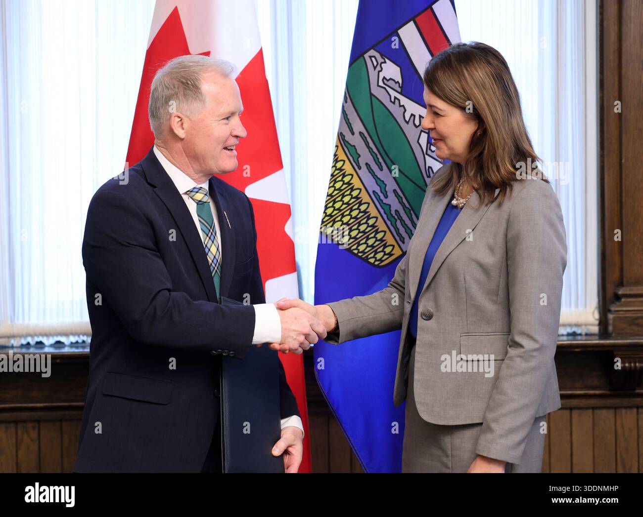 Alberta MLA Grant Hunter, left, shakes hands with Alberta Premier ...