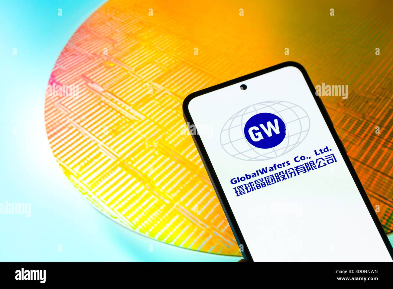 The GlobalWafers logo is being displayed on a mobile phone with a ...