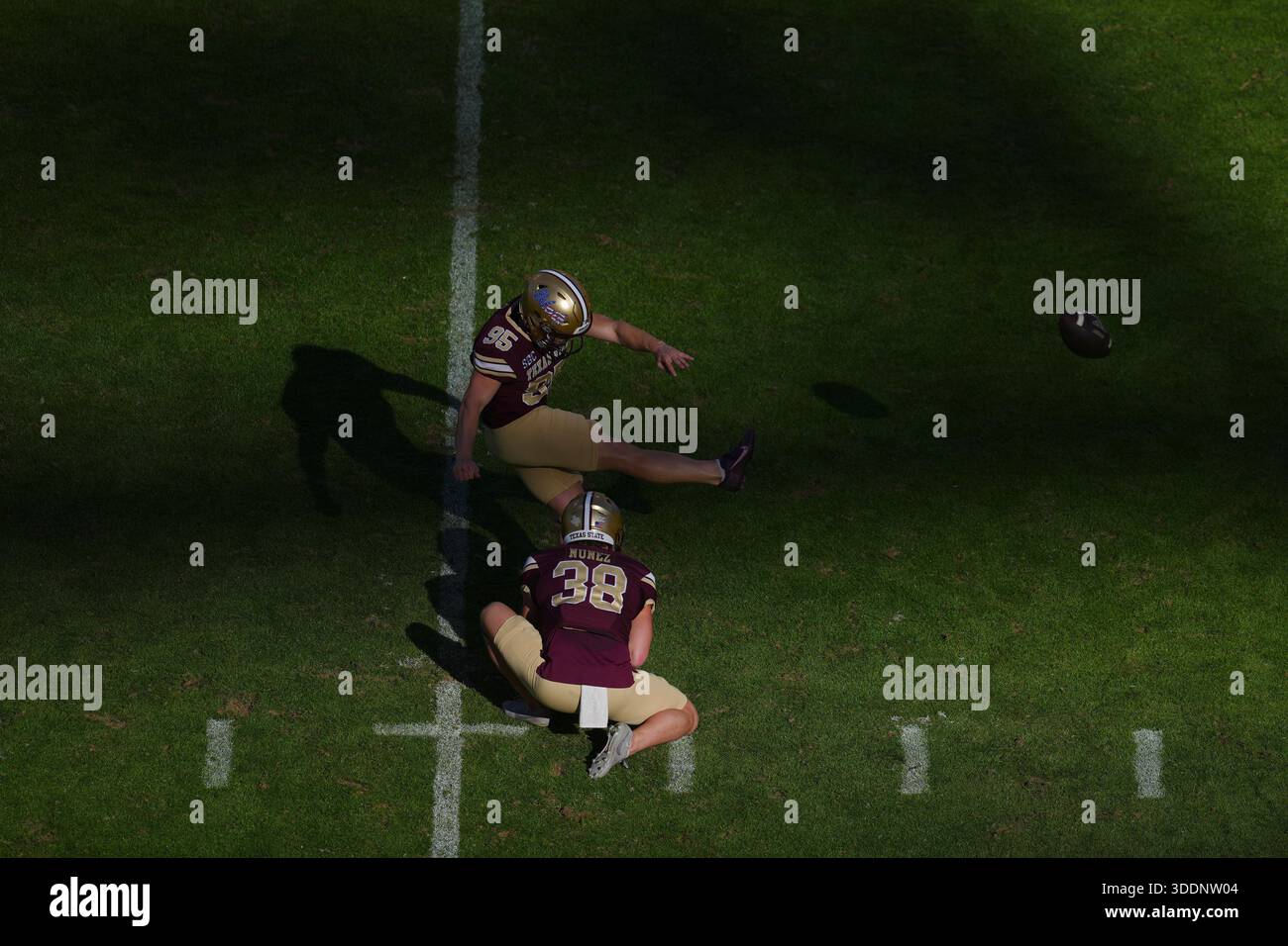 Texas State place kicker Tyler Robles (95), with David Nunez (38 ...