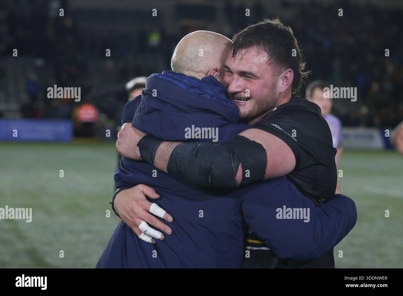 Connor Hancock of Newcastle Red Bulls embraces with Alan Dickens, Head ...