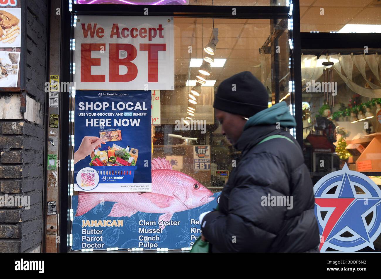 A store displays a sign accepting Electronic Benefits Transfer (EBT ...