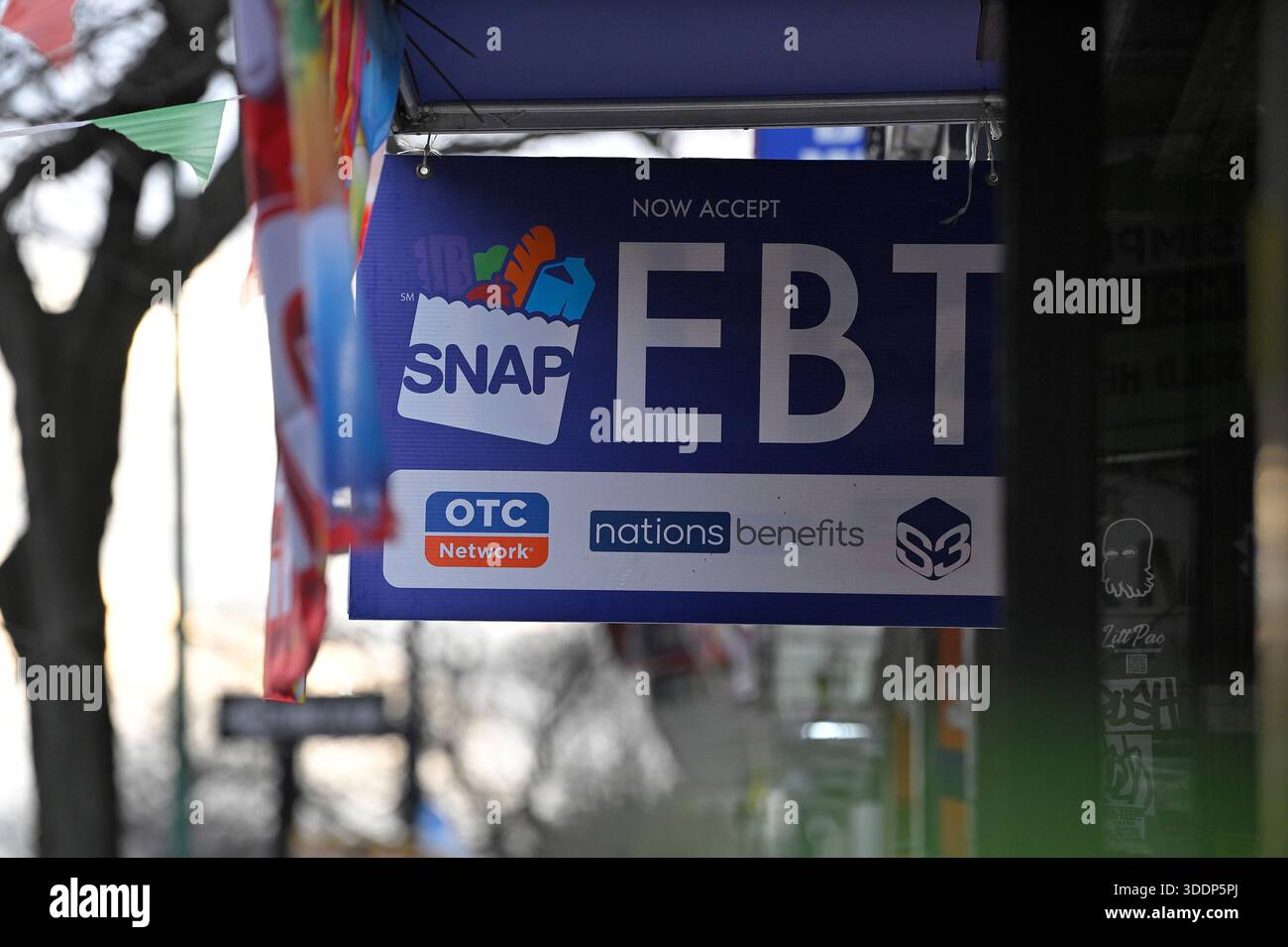 A store displays a sign accepting Electronic Benefits Transfer (EBT ...