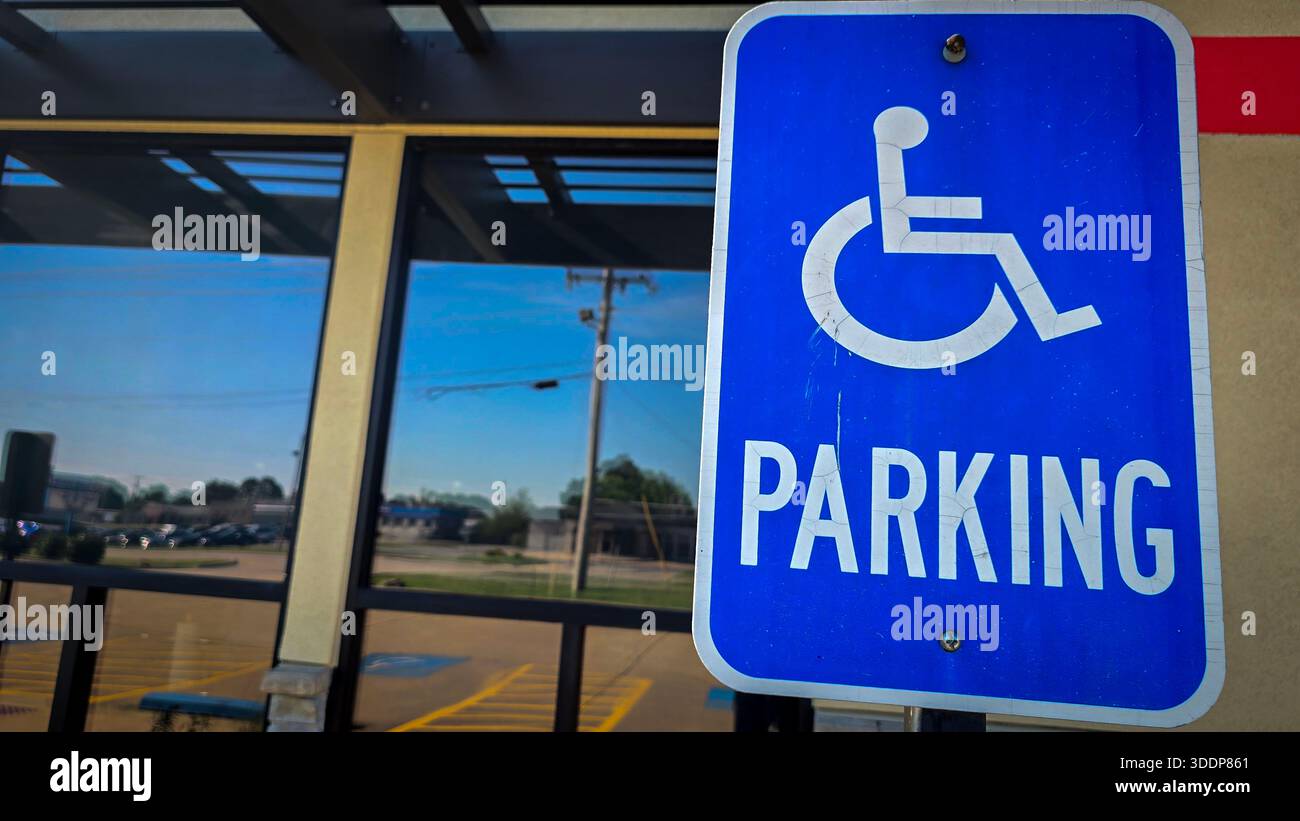 blue parking sign featuring a universal symbol for accessibility and ...