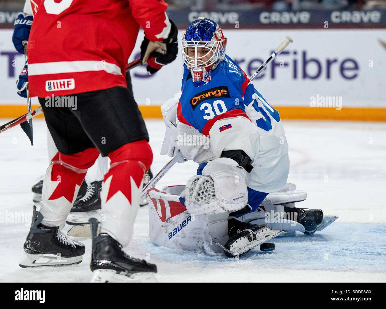 Canada's Cole Beaudoin (lefft) shoots on Slovakia goaltender Alan ...