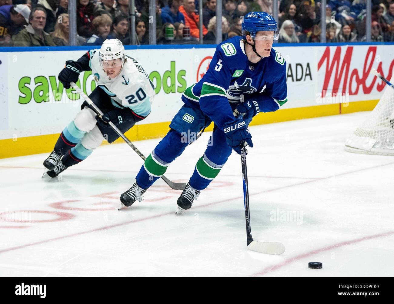 Seattle Kraken's Eeli Tolvanen (20) and Vancouver Canucks' Tom ...