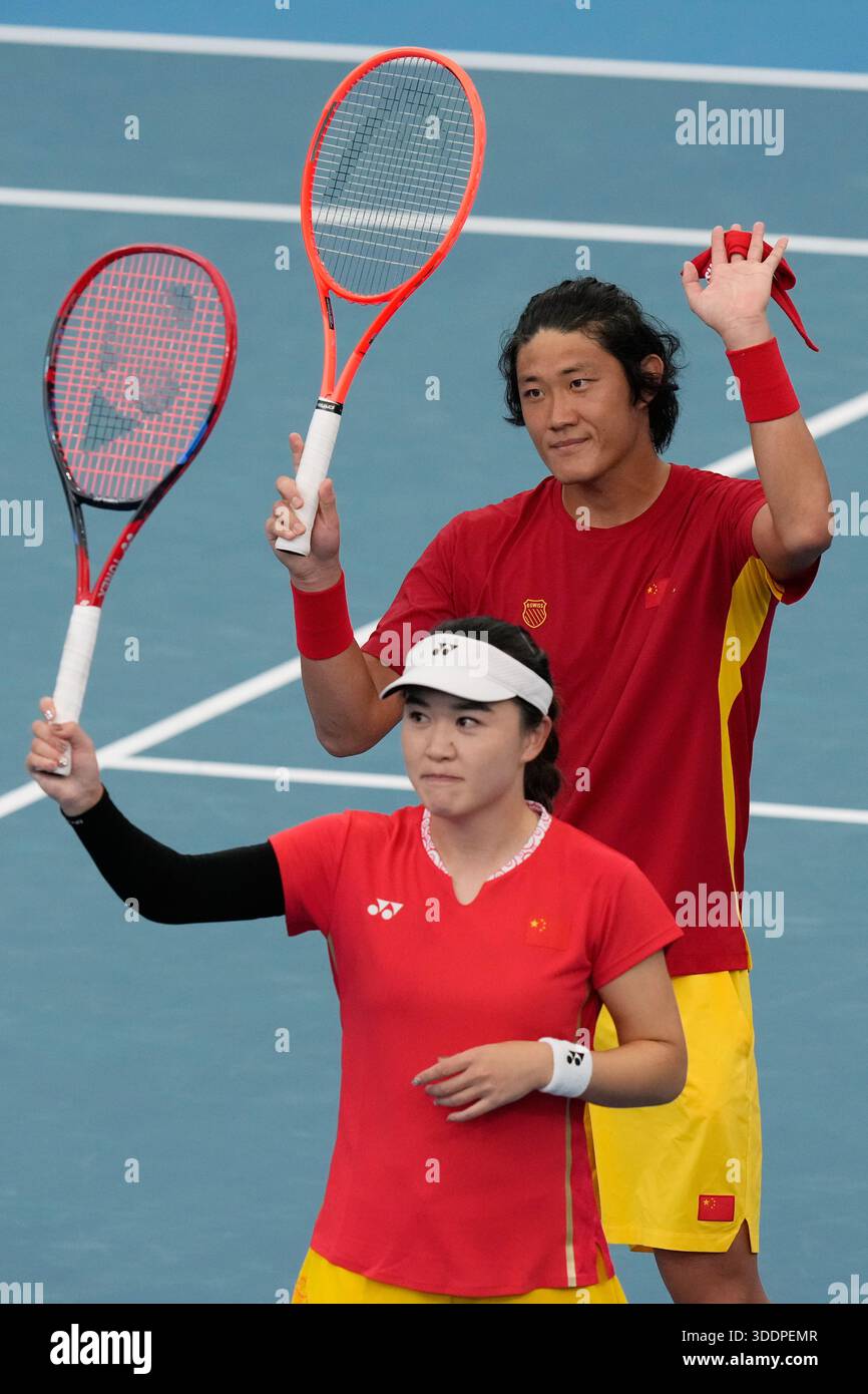 Zhizhen Zhang, top, and Lin Zhu of China wave after defeating Zizou ...