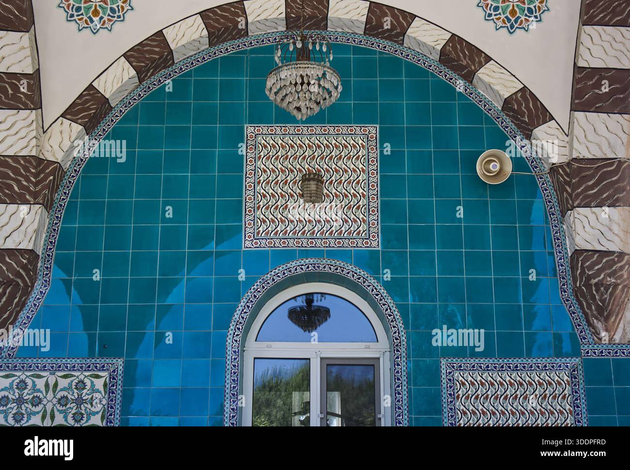 Decorative hand-painted ceiling and tiled wall in the ablution area of ...