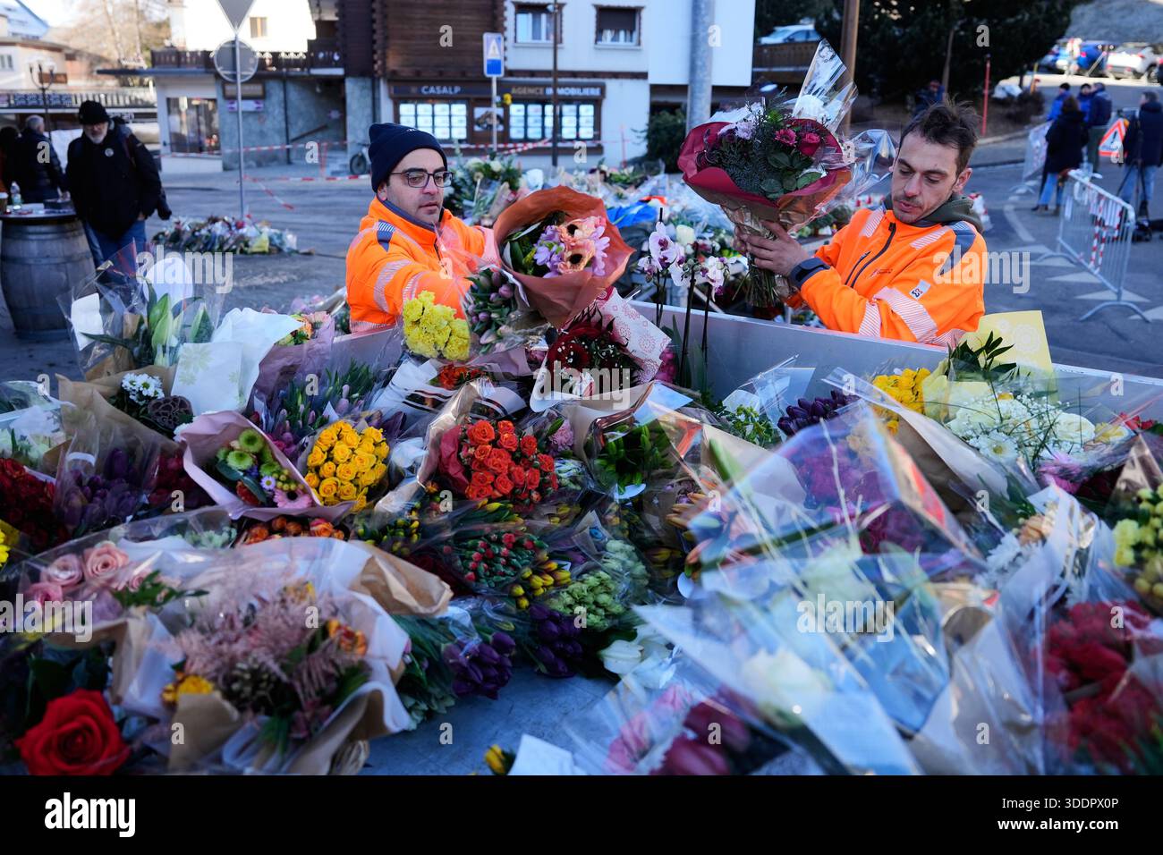 Municipal workers move flowers closer to the sealed off Le ...