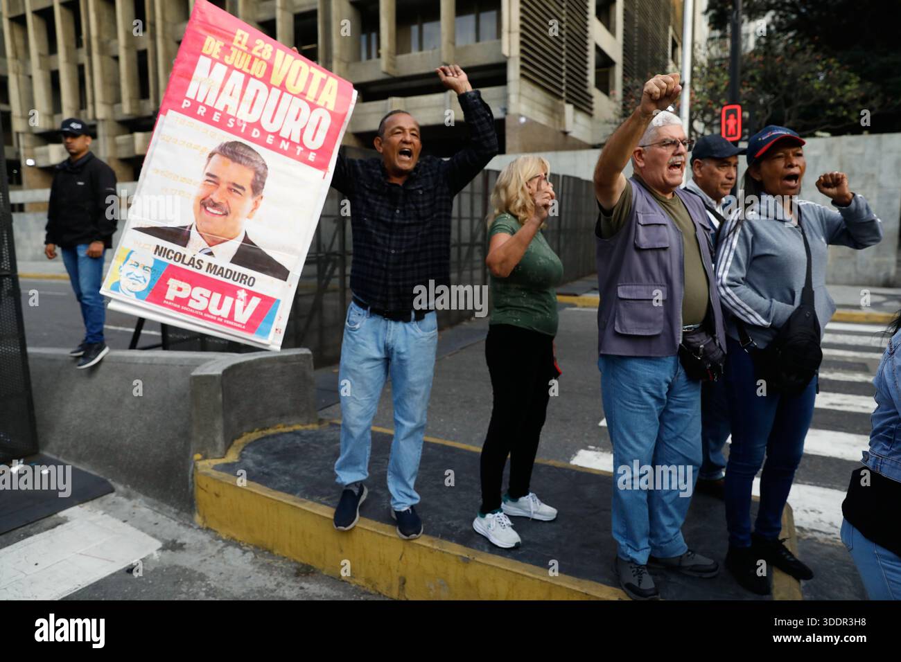 Supporters display a poster of Venezuelan President Nicolás Maduro in ...