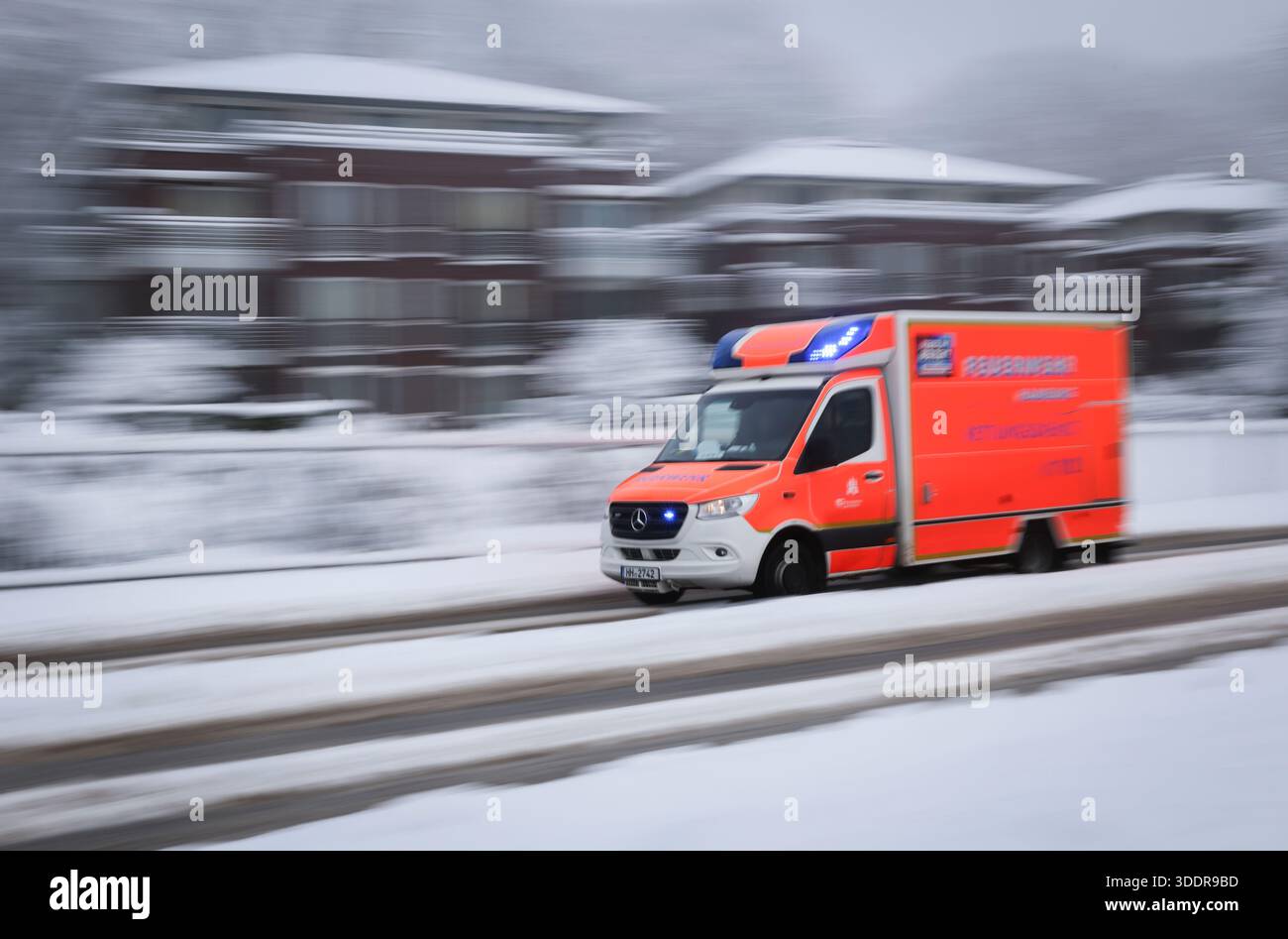 03 January 2026, Hamburg: A fire department ambulance is on its way to ...