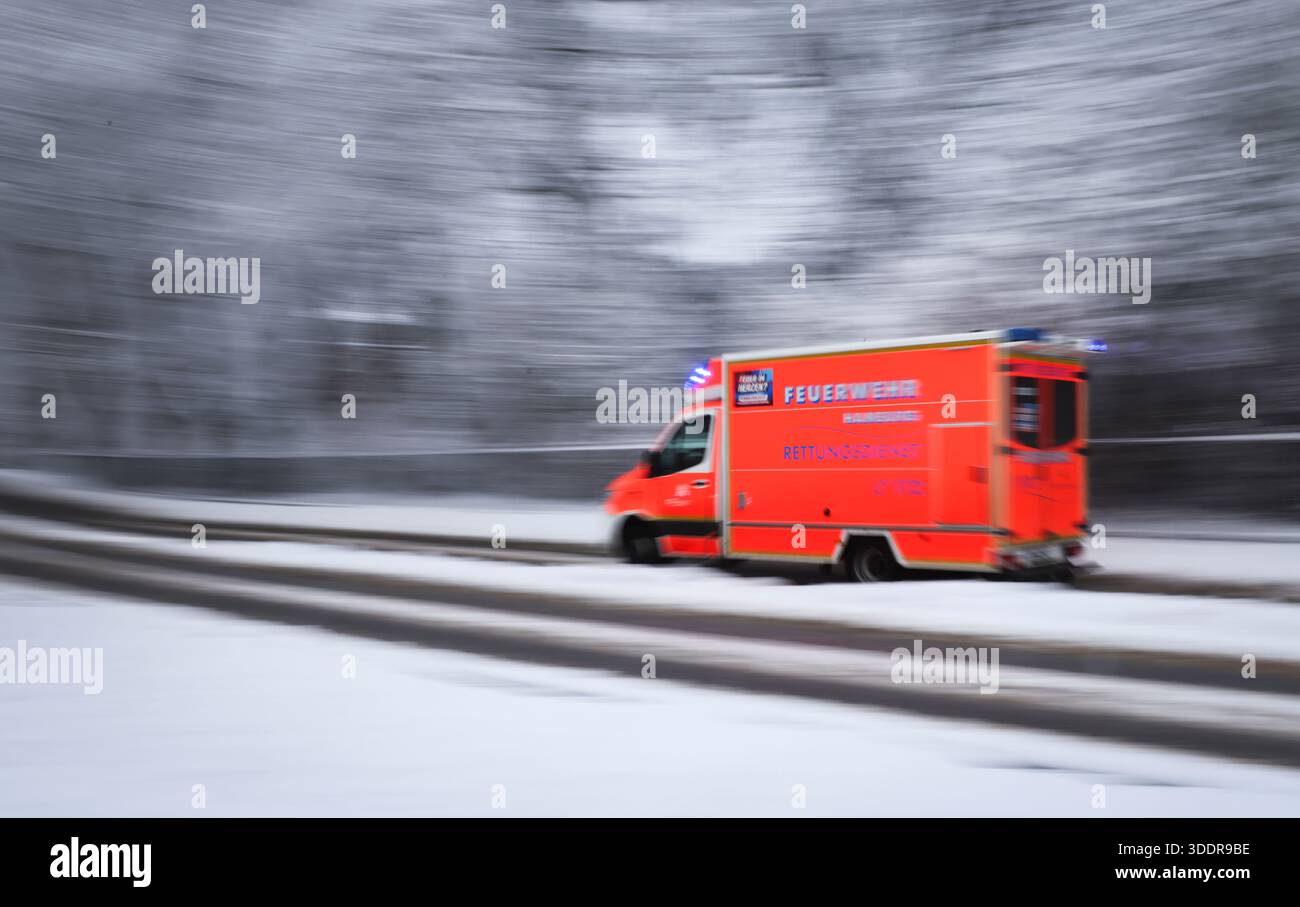 03 January 2026, Hamburg: A fire department ambulance is on its way to ...