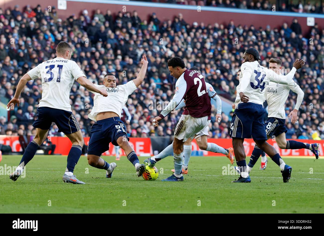 Aston Villa's Morgan Rogers (centre right) has a shot blocked by ...