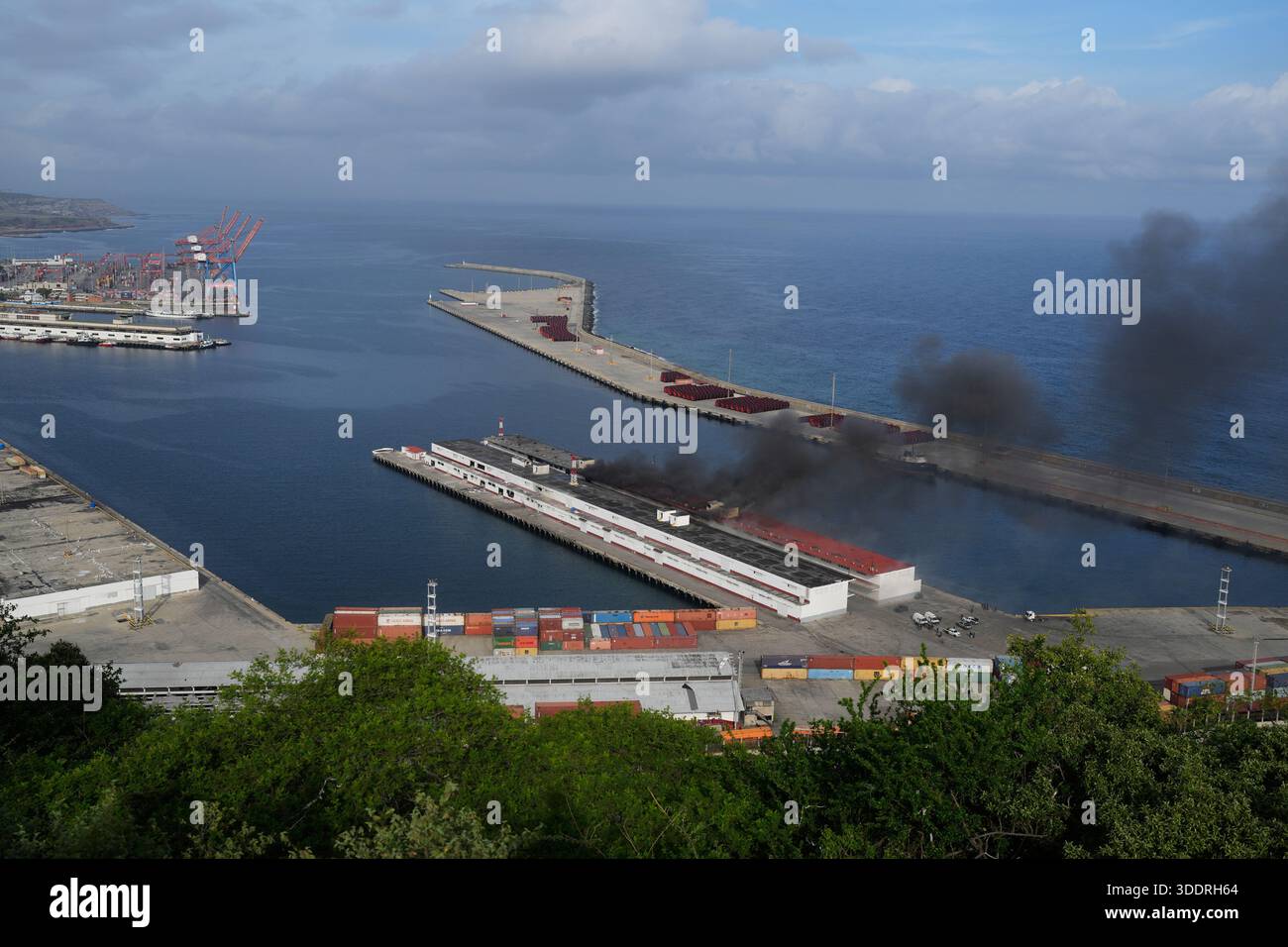 Smoke rises from a dock after explosions were heard at La Guaira port ...
