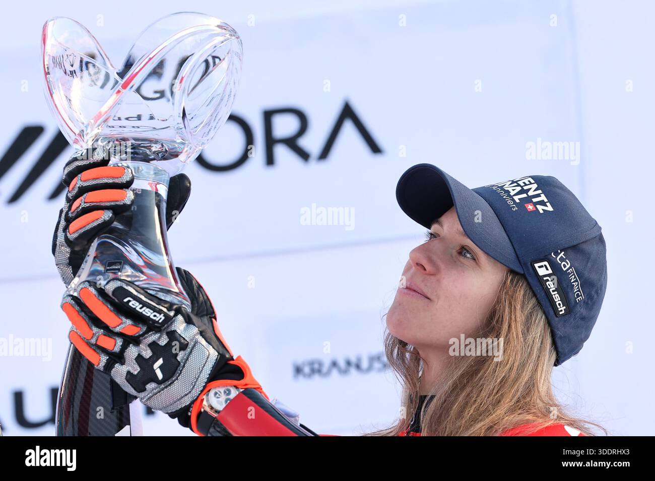 Switzerland's Camille Rast looks at the trophy as she stands on the ...