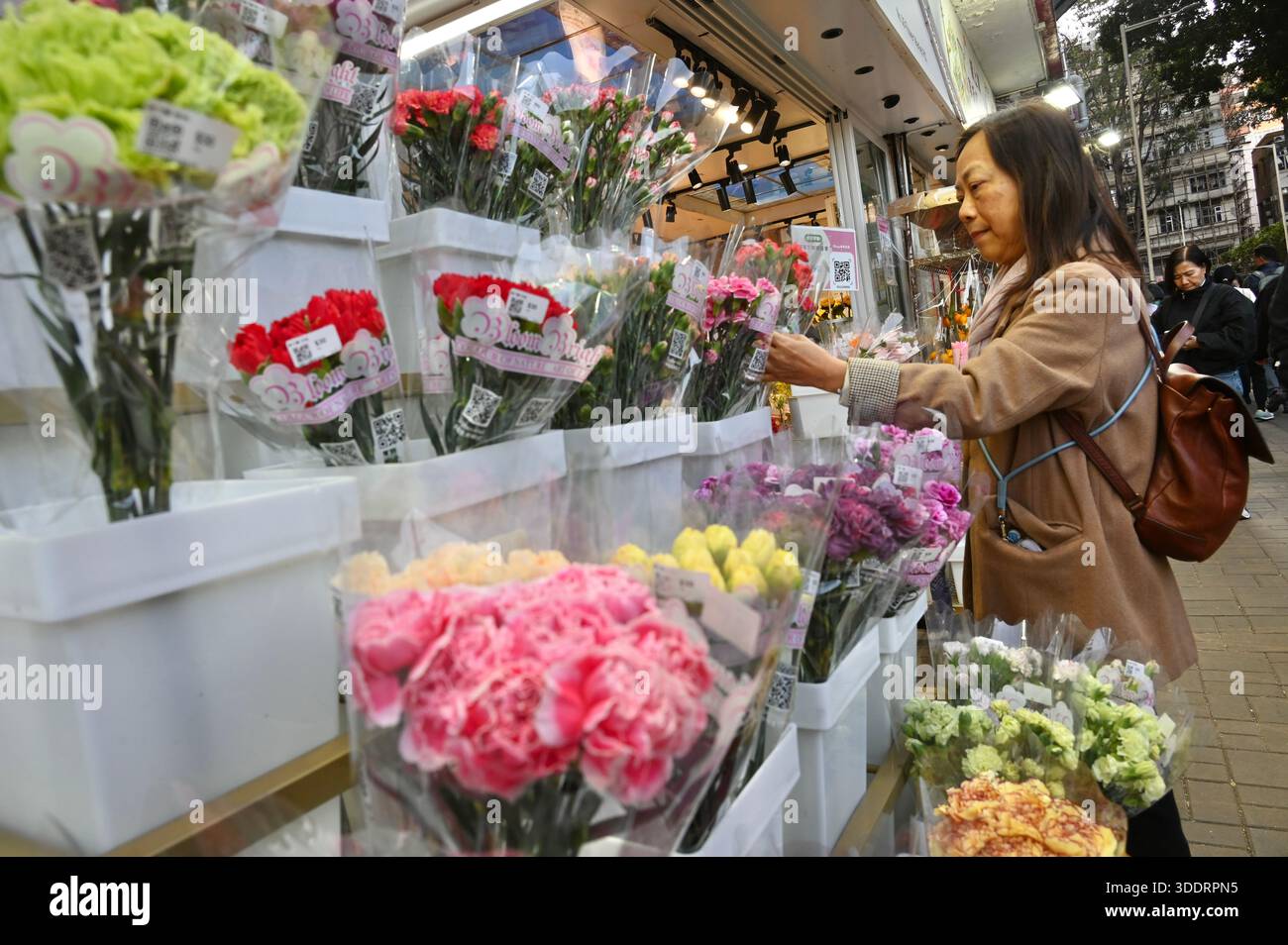 A general view showing a lady choosing the Chinese New Year Flowers on ...