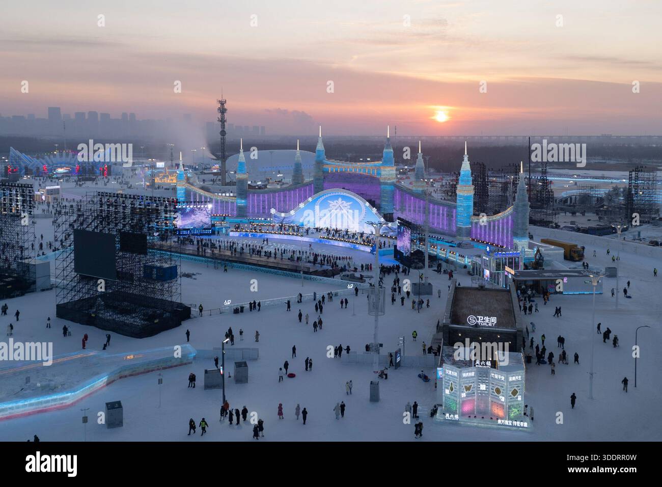 The sun sets over the annual Ice and Snow Festival held in Harbin in ...