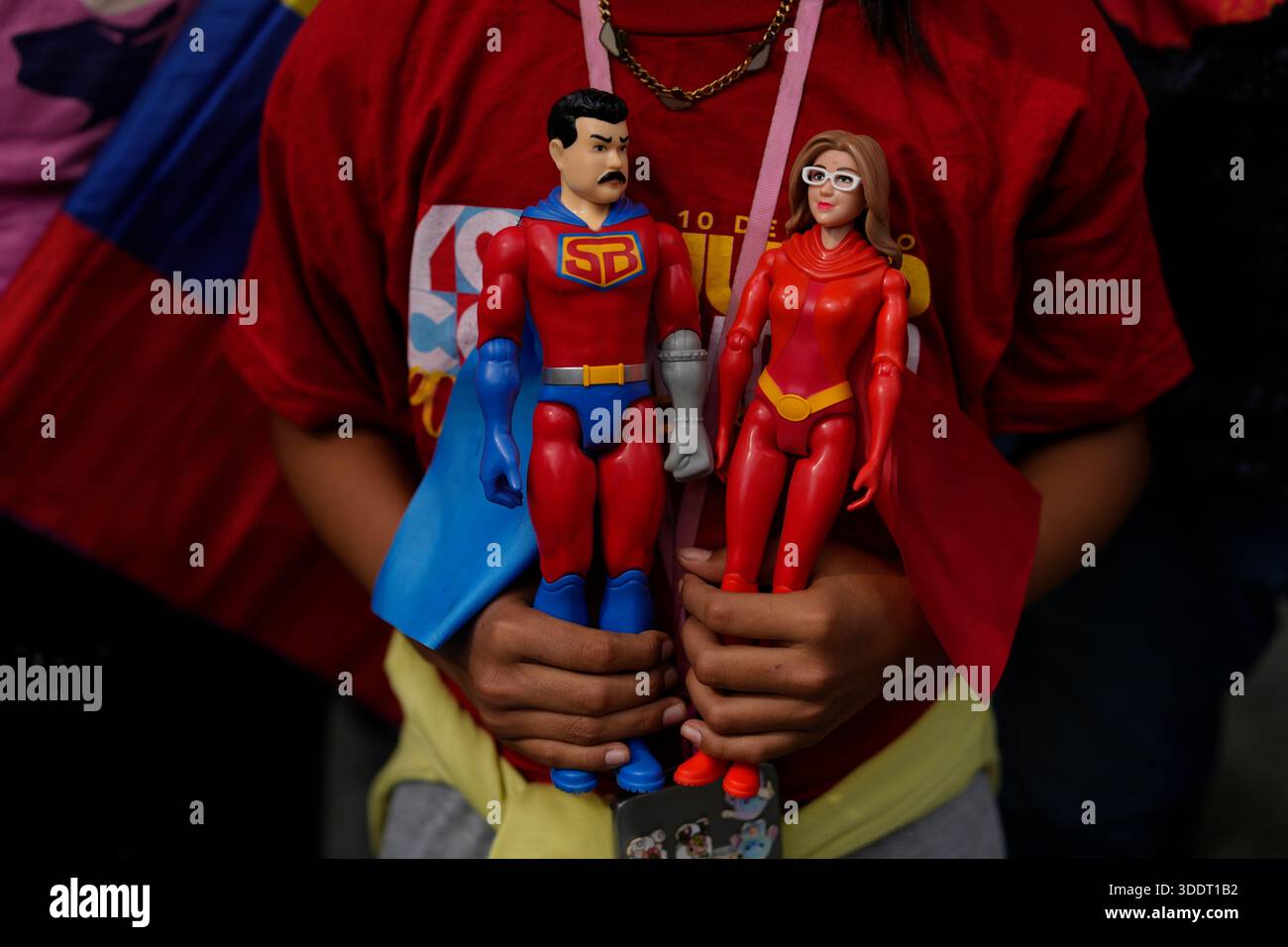 FILE - A child holds super hero dolls depicting President Nicolas ...