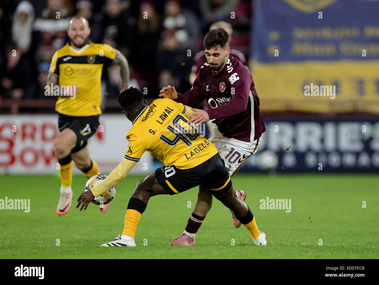 Livingston's Samson Lawal (left) and Heart of Midlothian's Claudio ...