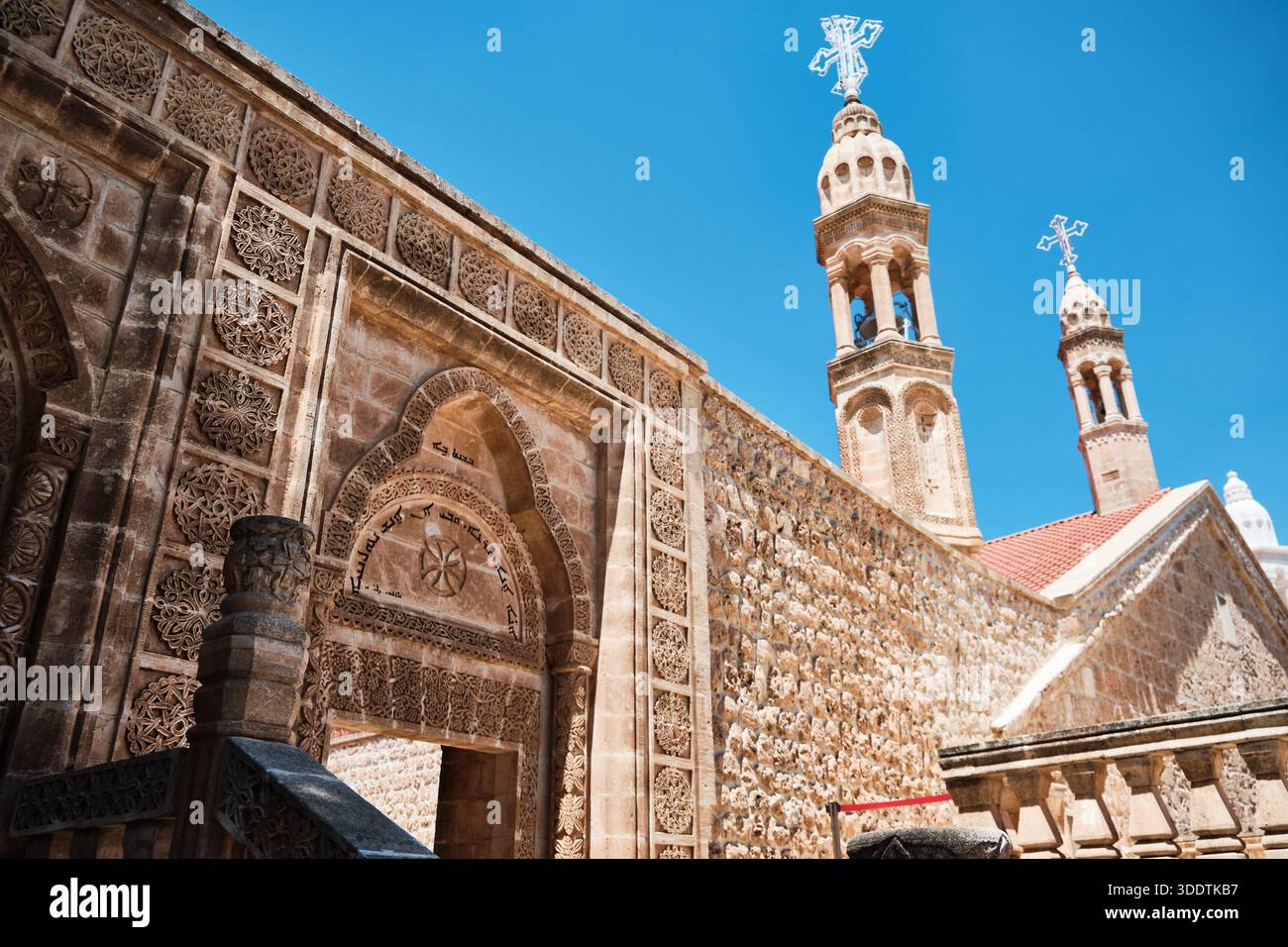 Low-angle view of historic stone church featuring arched entrances and ...