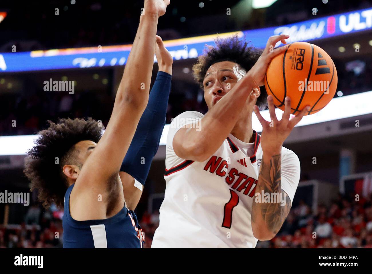 North Carolina State's Darrion Williams (1) tries to pass the ball past ...