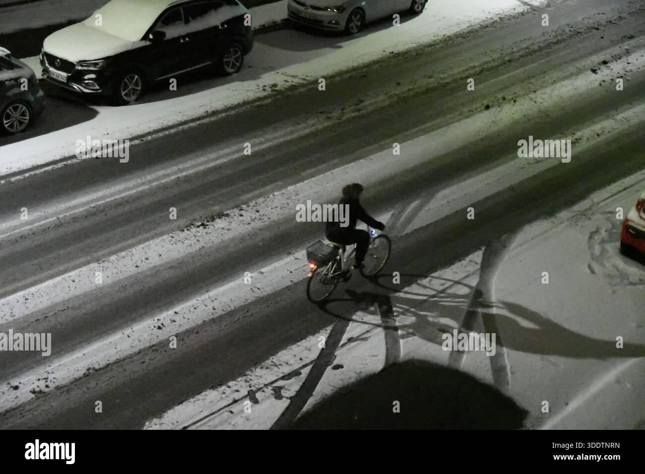 kASTRUP/Copenhagen/ Denmark/03 JAN 2026/Biker in snow fall weather on ...