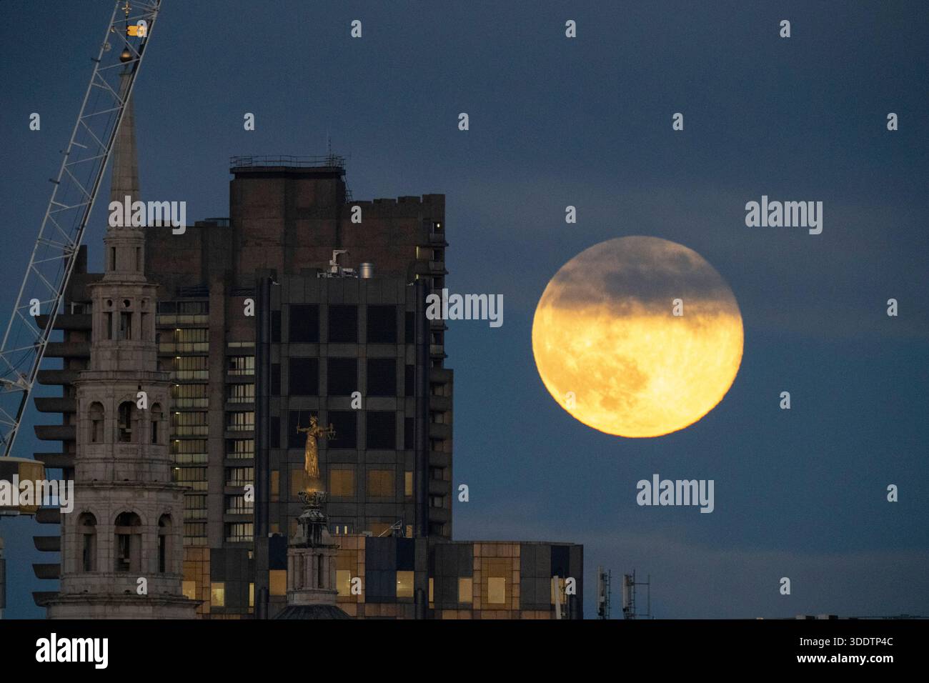 A full moon rises over London. The first full moon - the Wolf moon ...
