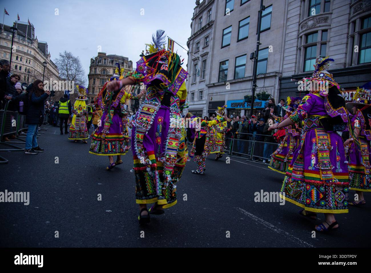 Performers in elaborate costumes entertain the crowd during the London ...
