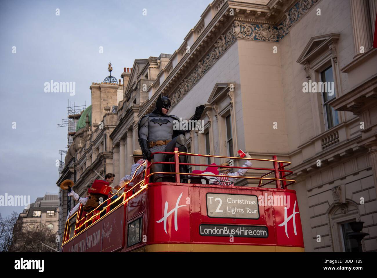 A character Batman on top of London red bus greets fans during the ...