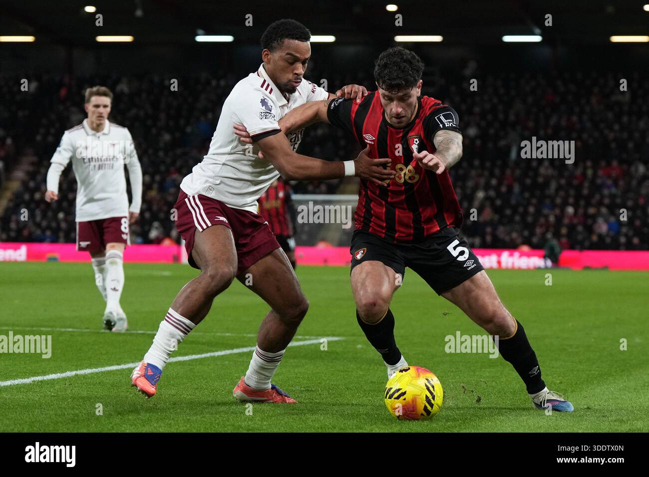 Arsenal's Jurrien Timber, left, challenges Bournemouth's Marcos Senesi ...