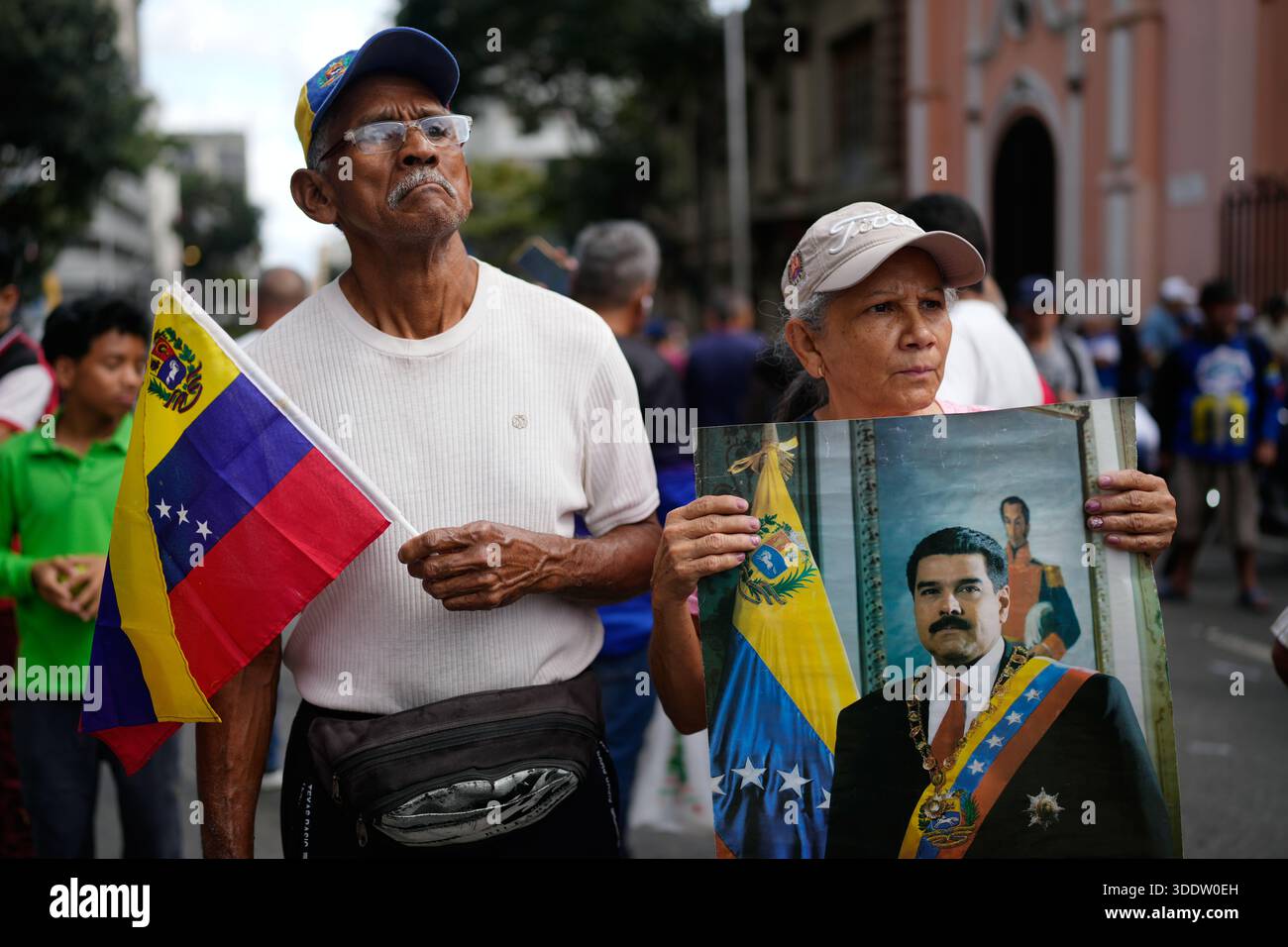 A supporter holds a poster of Venezuelan President Nicolás Maduro in ...