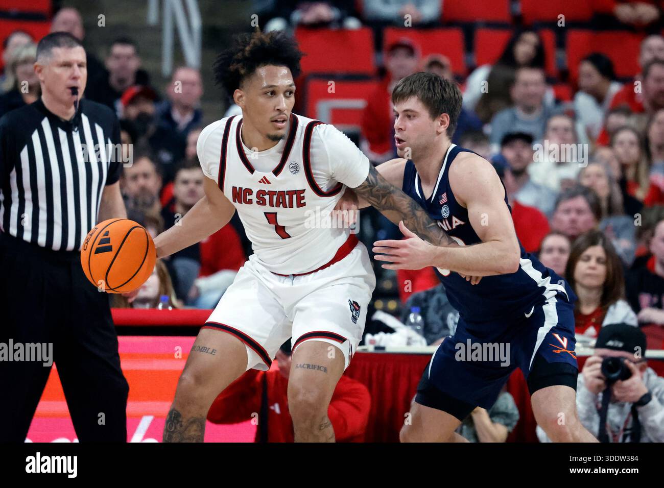 North Carolina State's Darrion Williams (1) brushes off Virginia's ...