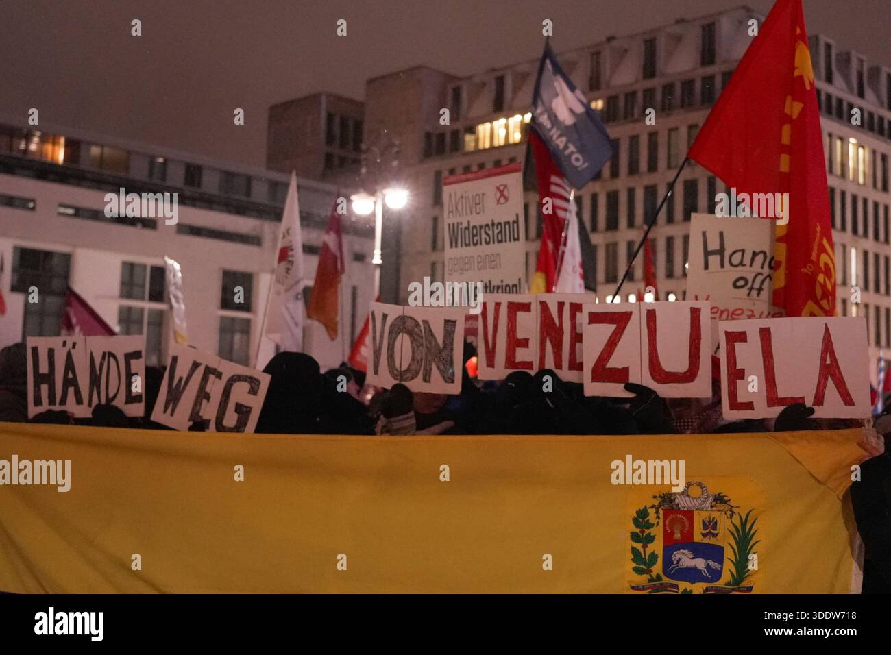 People hold banner reading 'Haende weg von Venezuela' (Hands Off ...