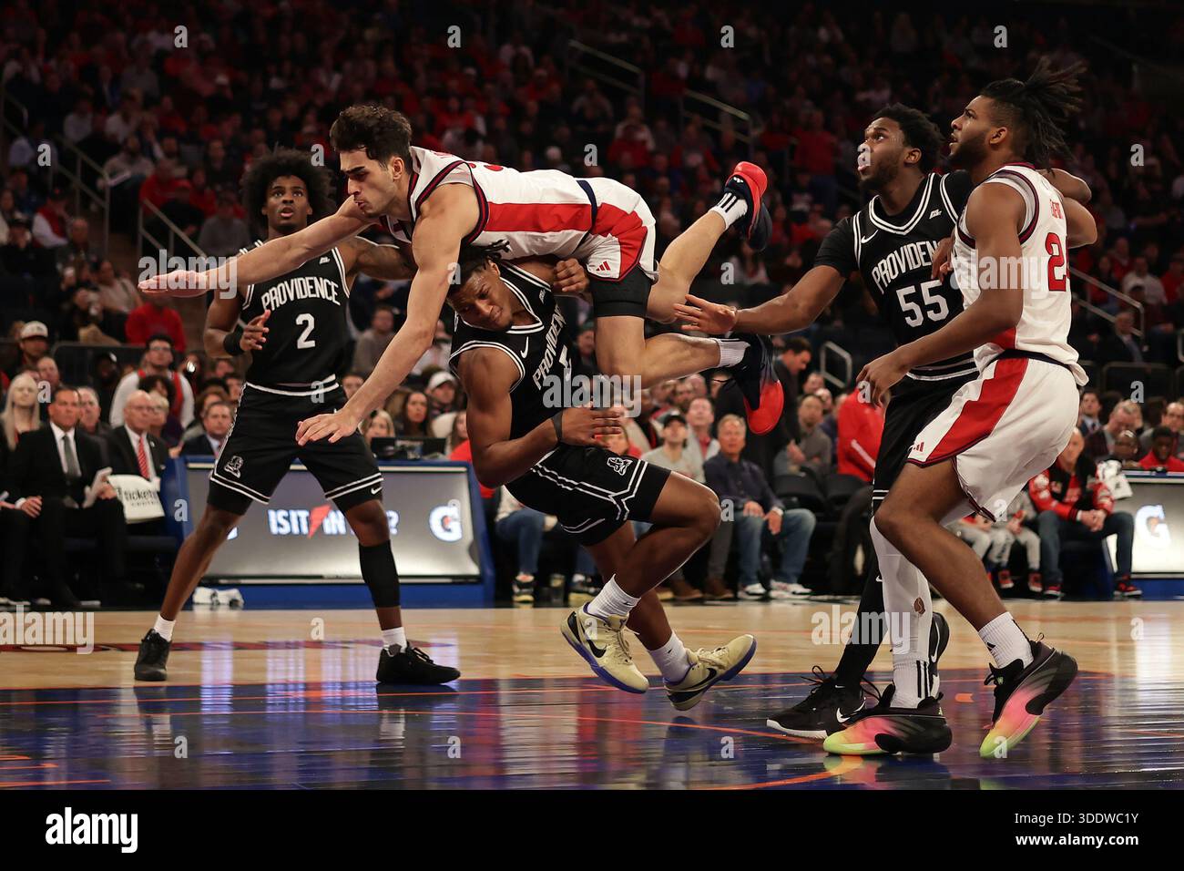 St. John's guard Lefteris Liotopoulos, top, is fouled by Providence ...