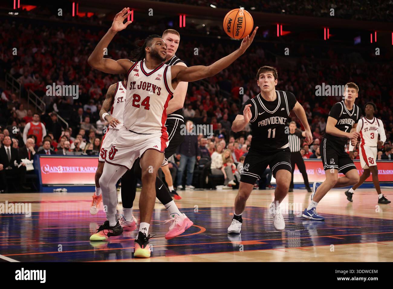 St. John's forward Zuby Ejiofor (24) grabs a rebound in front of ...