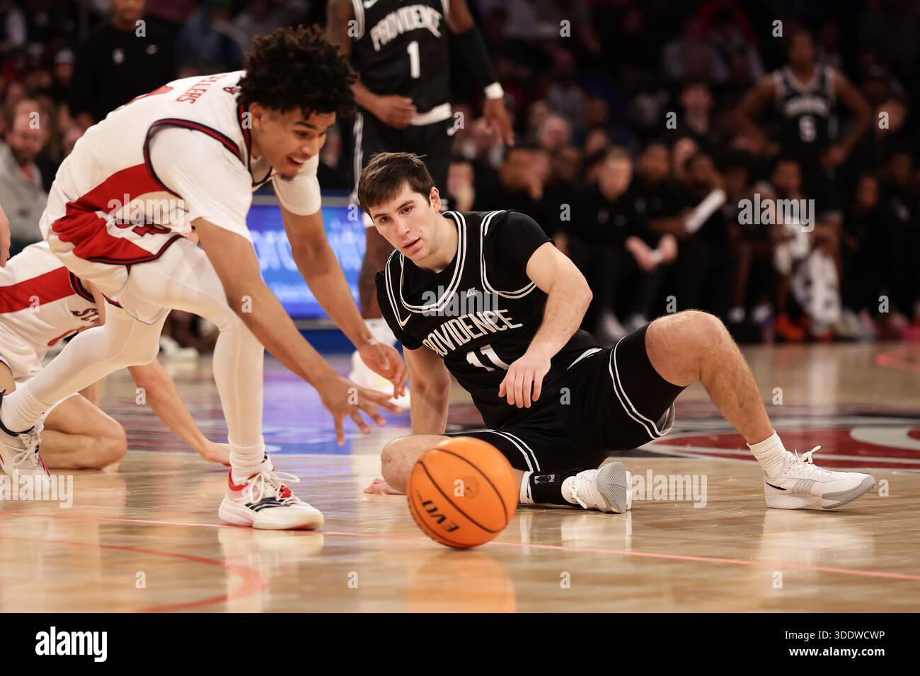 Providence guard Ryan Mela (11) looks on as St. John's guard Oziyah ...