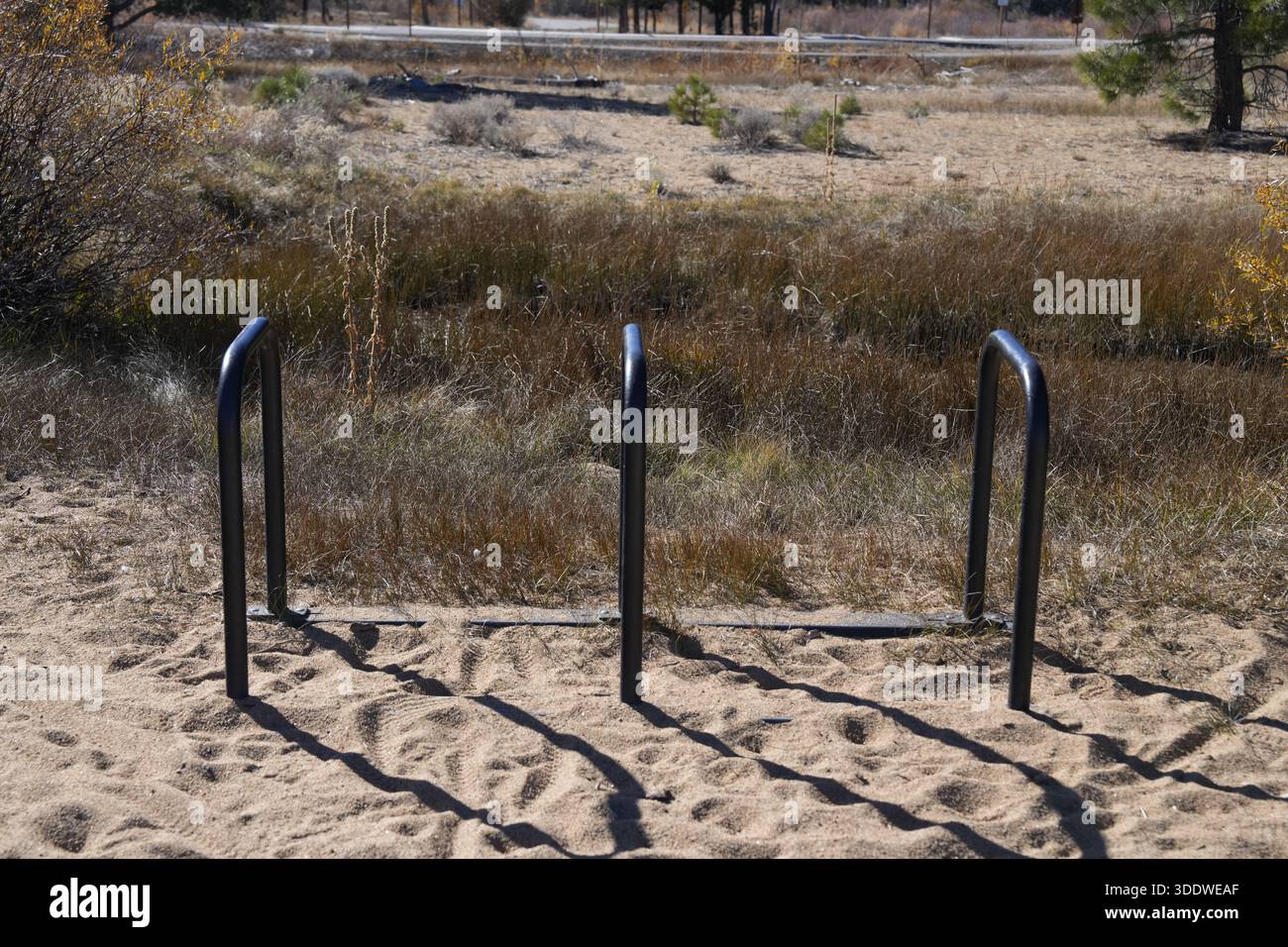 Simple black metal bike rack with three u shaped loops stands hi-res ...
