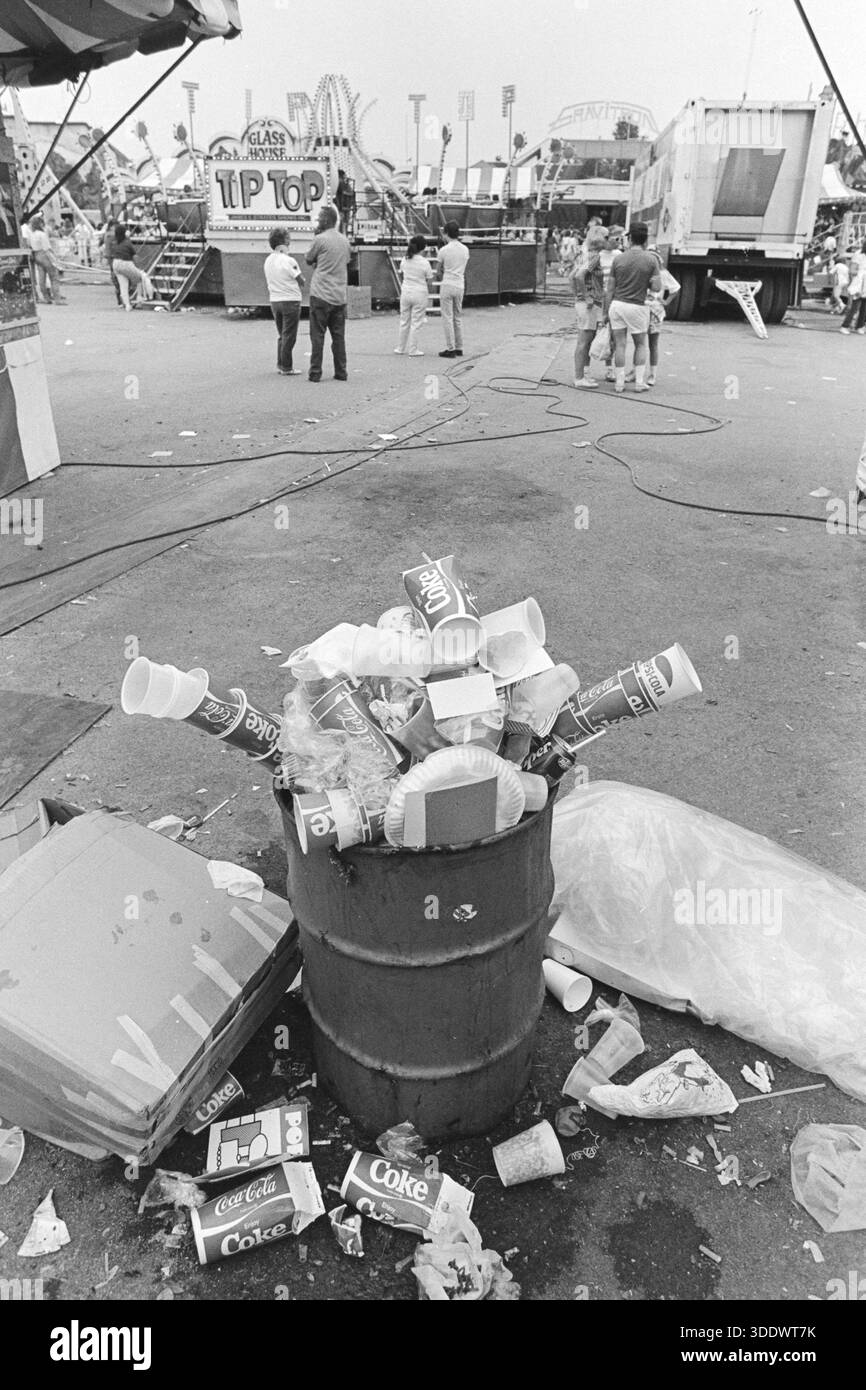 An overflowing oil drum serves as a makeshift trash can as Coca-Cola ...