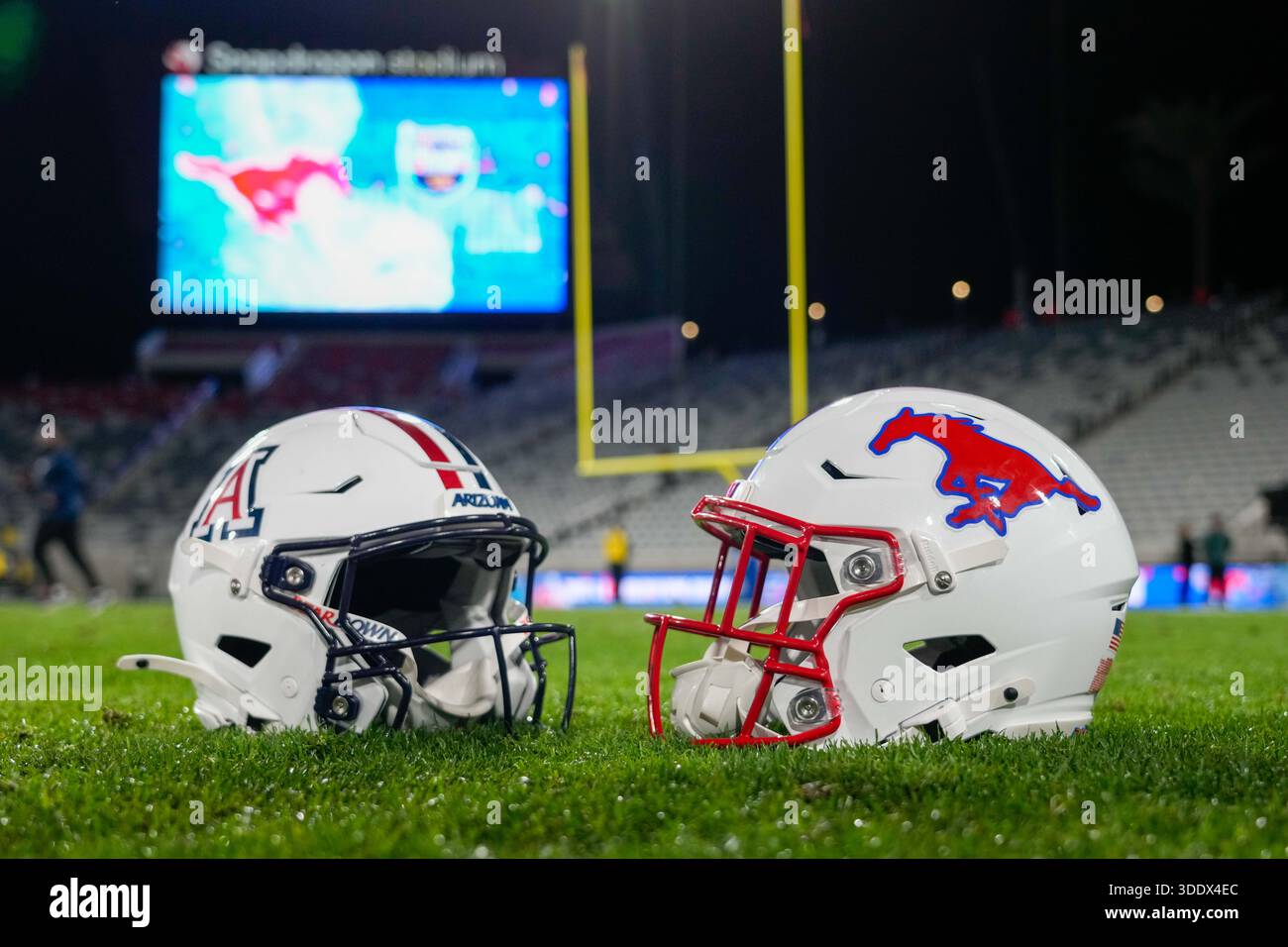 Arizona Wildcats and SMU Mustangs helmets sit on the field after the ...