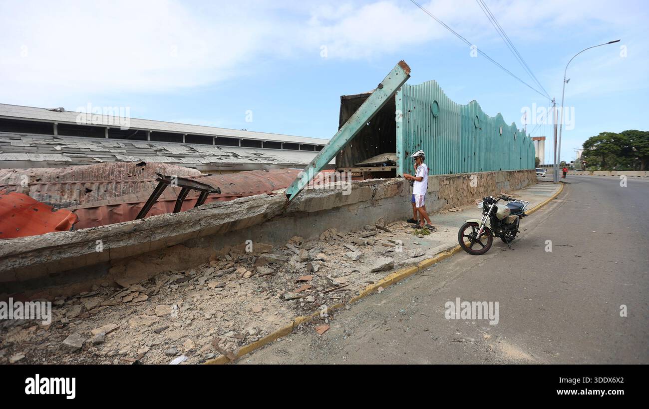 A Venezuelan man inspects the destruction left by U.S. missile strikes ...