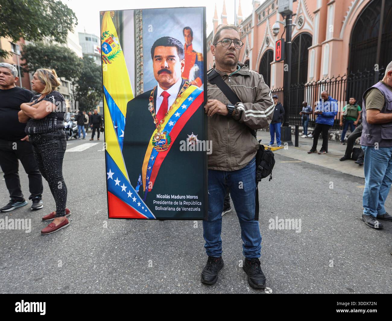 A person holds a portrait of Venezuelan President Nicolas Maduro during ...