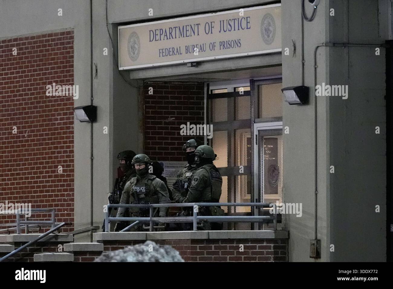 Department of Justice federal officers stand outside the DOJ Federal ...
