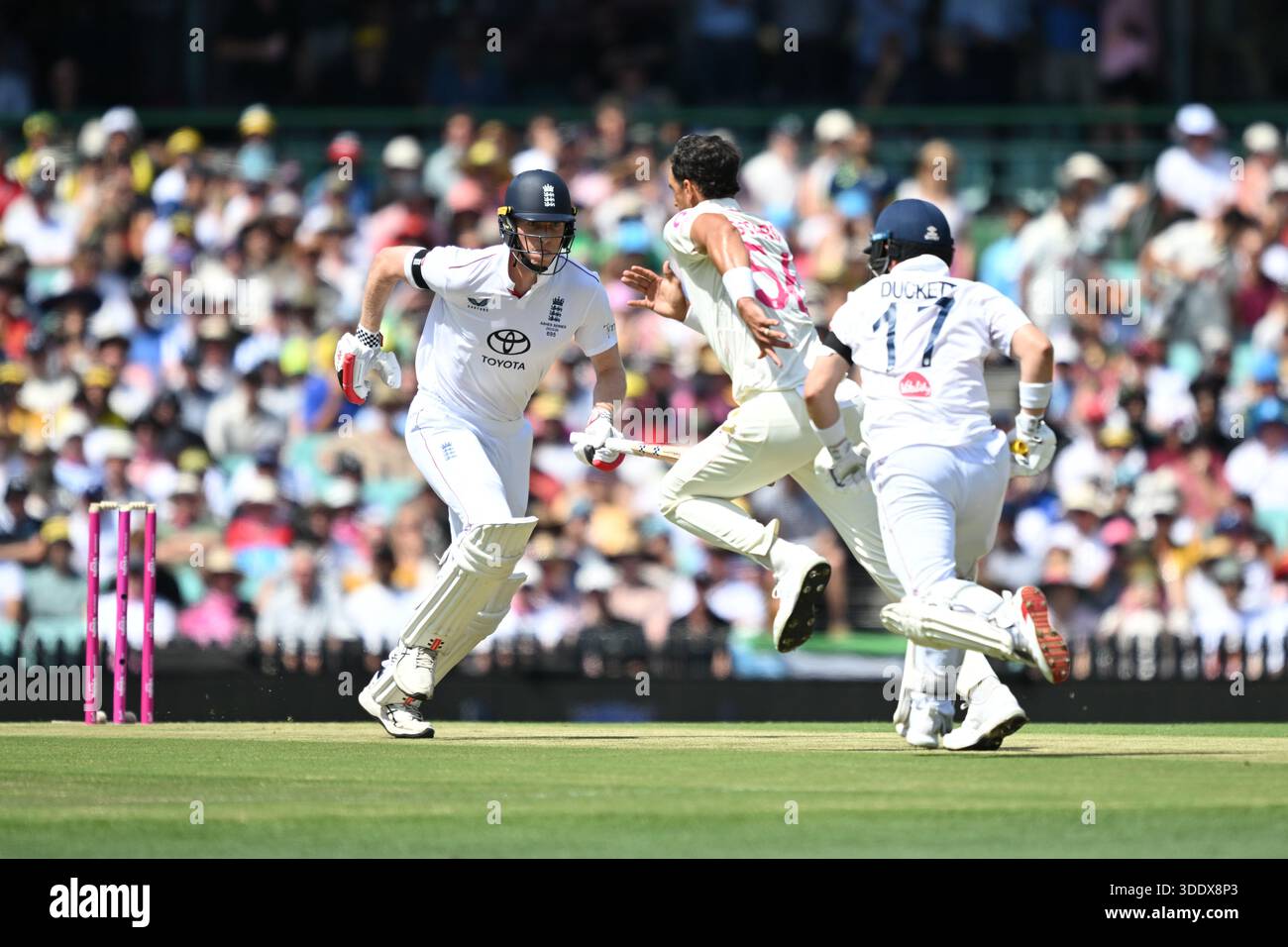 Zak Crawley and Ben Duckett of England run between the wickets as ...