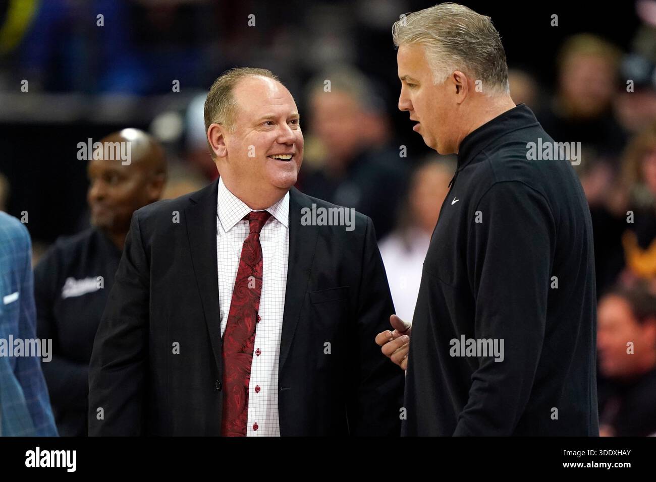 Wisconsin head coach Greg Gard, left, talks with Purdue head coach Matt ...