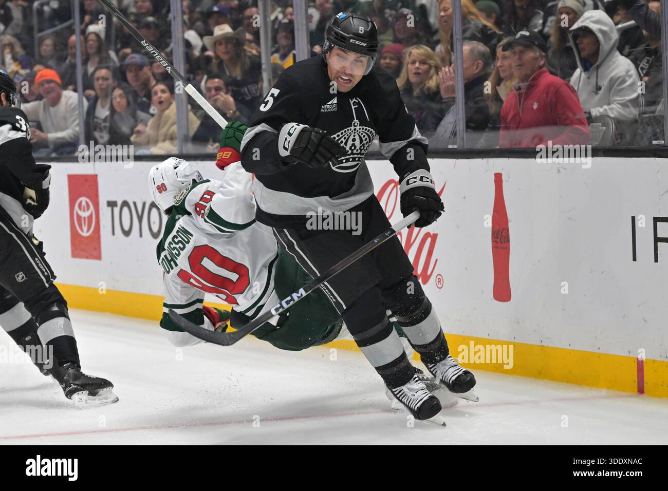 Minnesota Wild left wing Marcus Johansson, left, lands on the ice as he ...