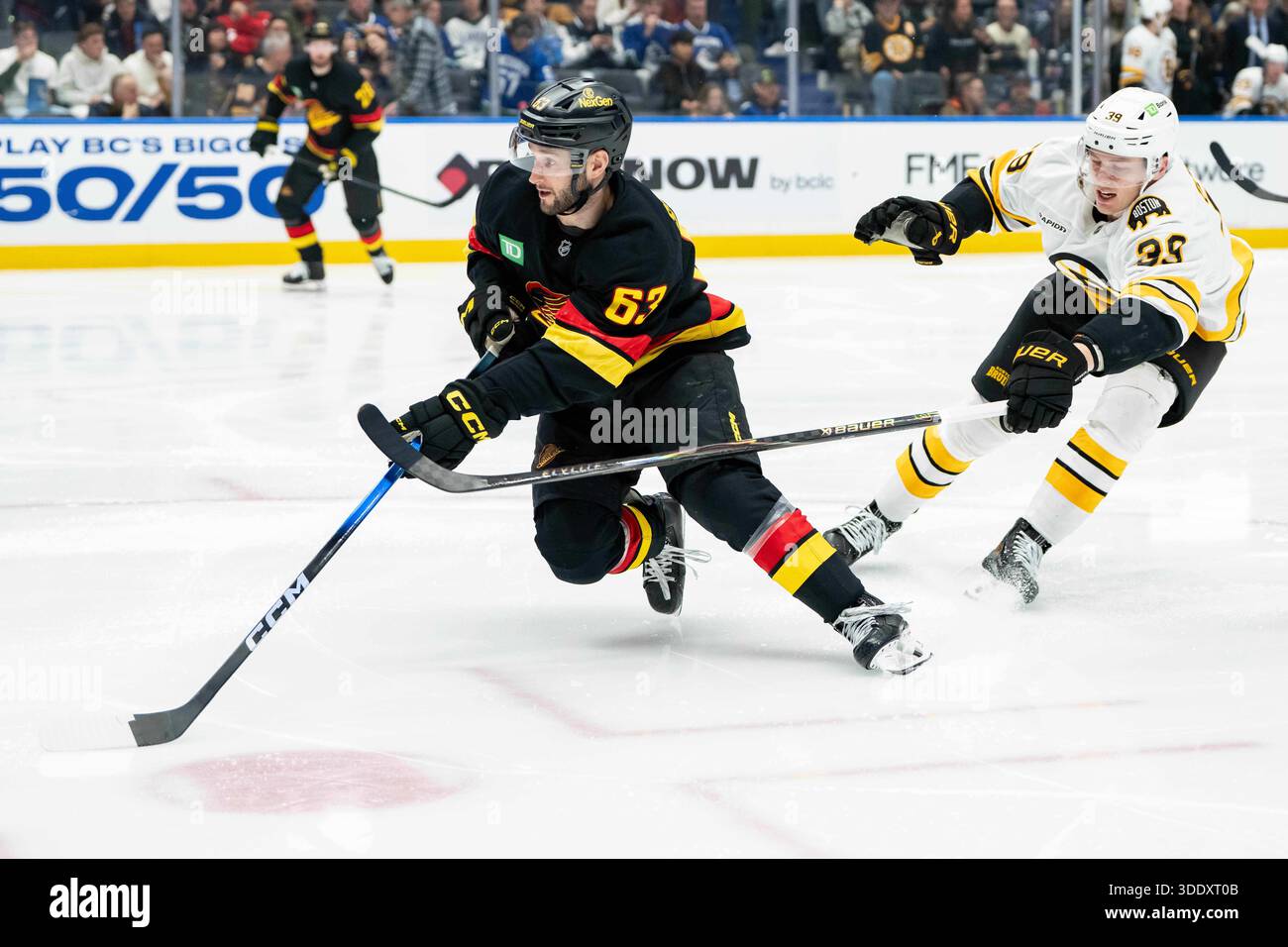 Vancouver Canucks' Max Sasson (63) skates with the puck as Boston ...