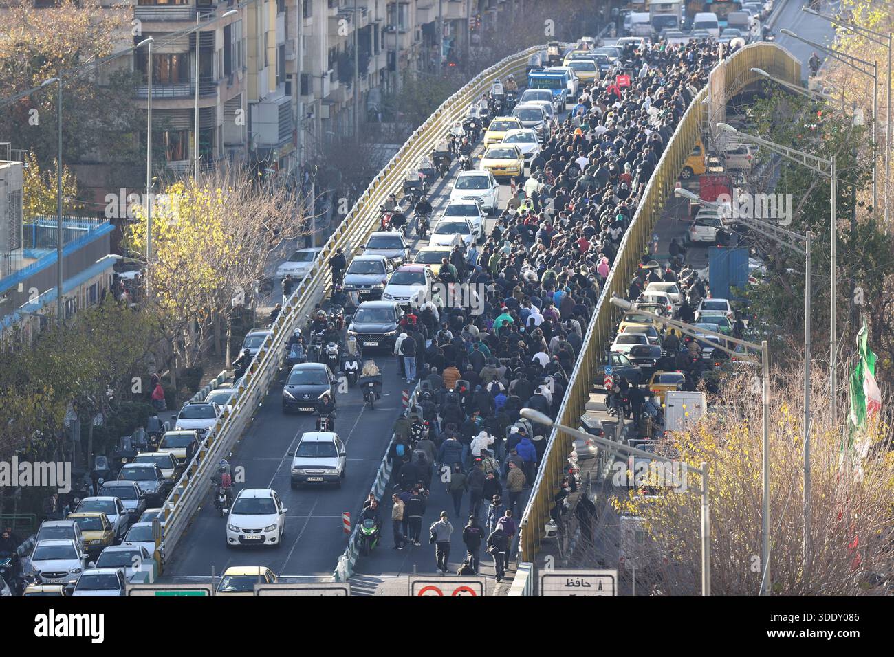 FILE - Protesters march on a bridge in Tehran, Iran, on Dec. 29, 2025 ...