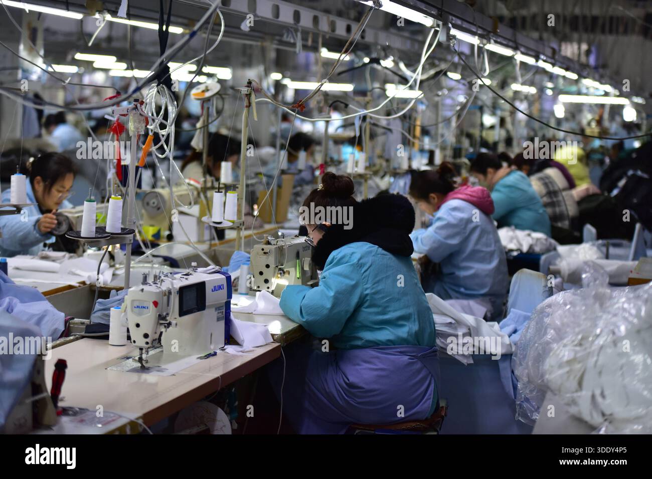 Women work at a factory producing shirts in Fuyang in central China's ...
