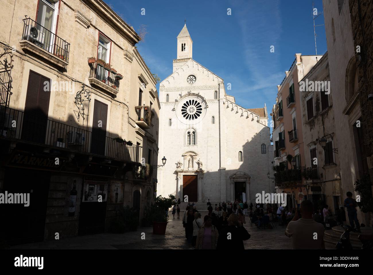 12 October 2025, Italy, Bari: Passers-by stand in front of Bari ...